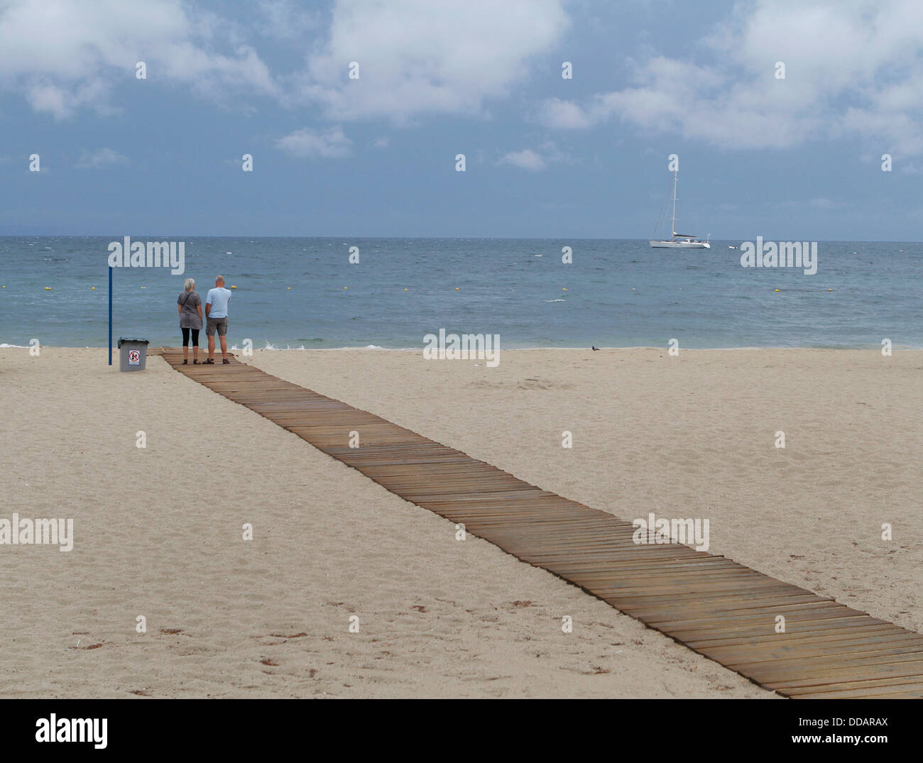 A couple watch the ocean in the Spanish Mallorca´s beach of Magaluf ...
