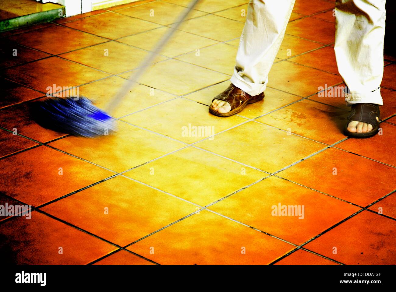 Man mopping the floor of the terrace Stock Photo - Alamy