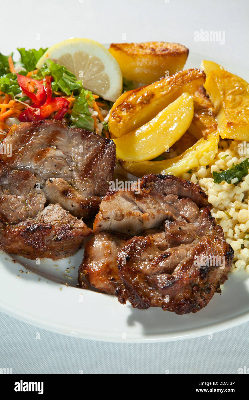 Beef chicken pork meat cooked grilled served with rice potatoes red and ...