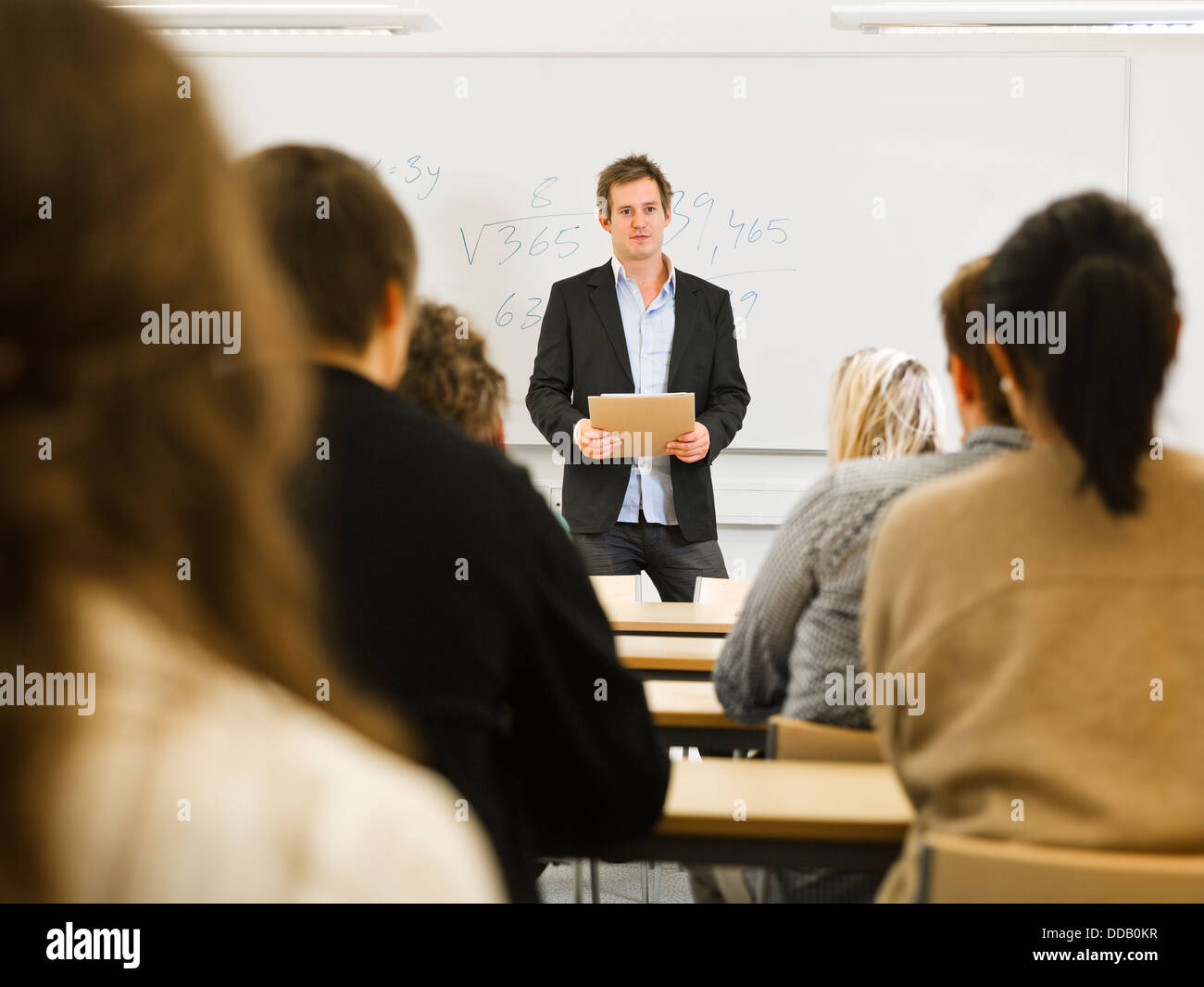 Teacher in classroom Stock Photo - Alamy