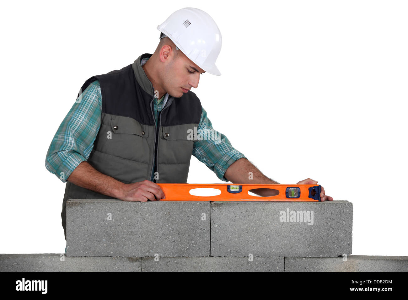 Mason making necessary checks with spirit level Stock Photo - Alamy