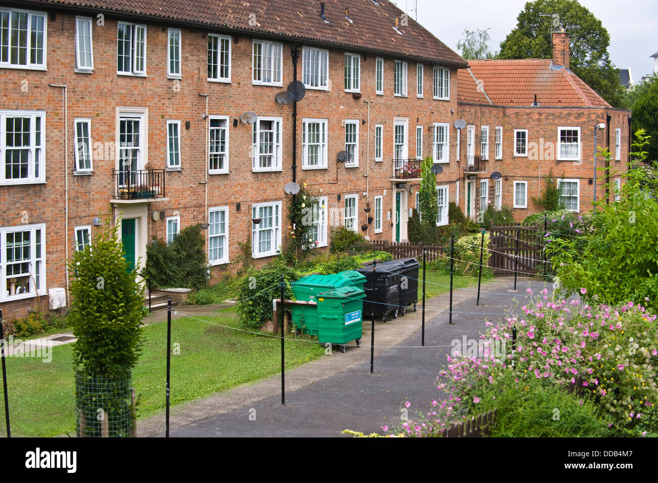Exterior of apartment building with washing lines and community rubbish ...