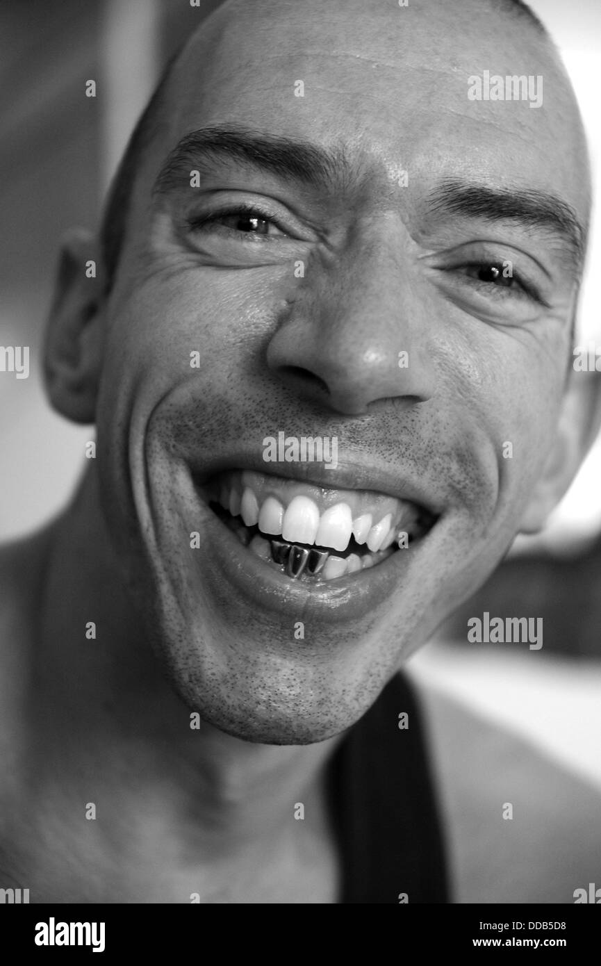 Portrait of young man smiling with 3 gold teeth showing he is former ...