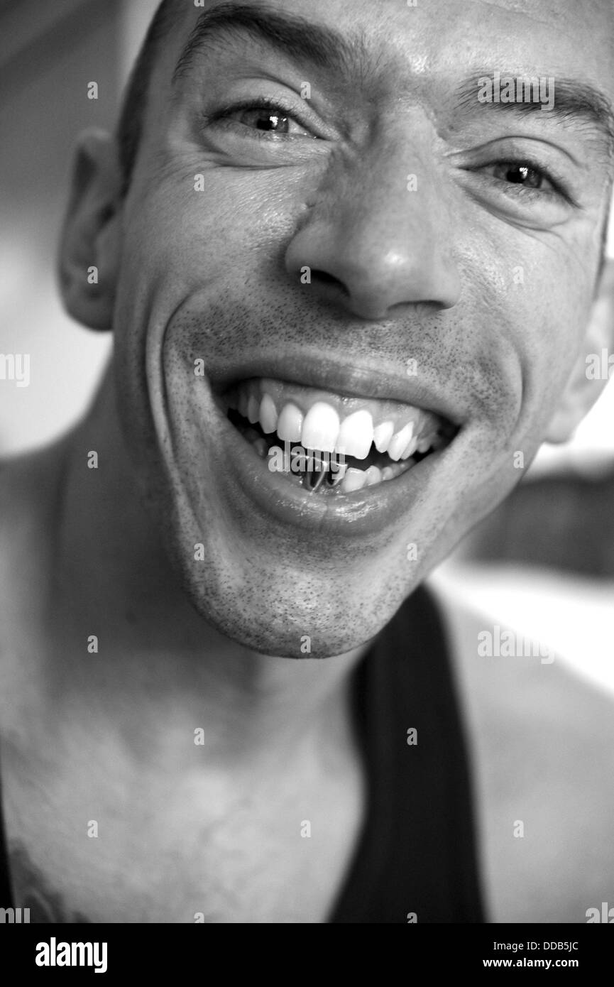 Portrait of young man smiling with 3 gold teeth showing he is former ...