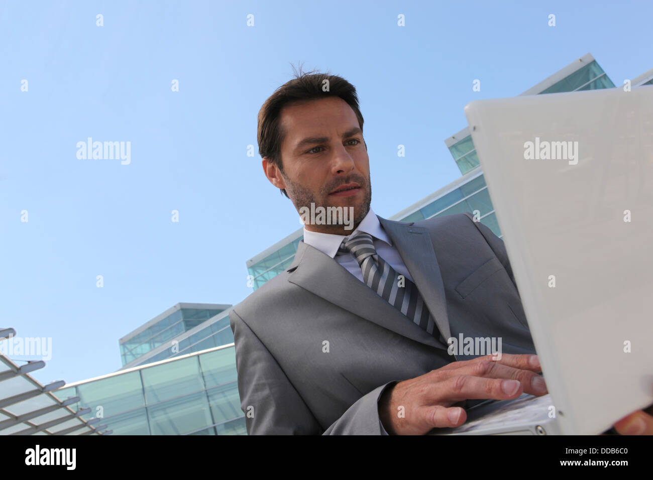 Businessman on laptop outside Stock Photo - Alamy