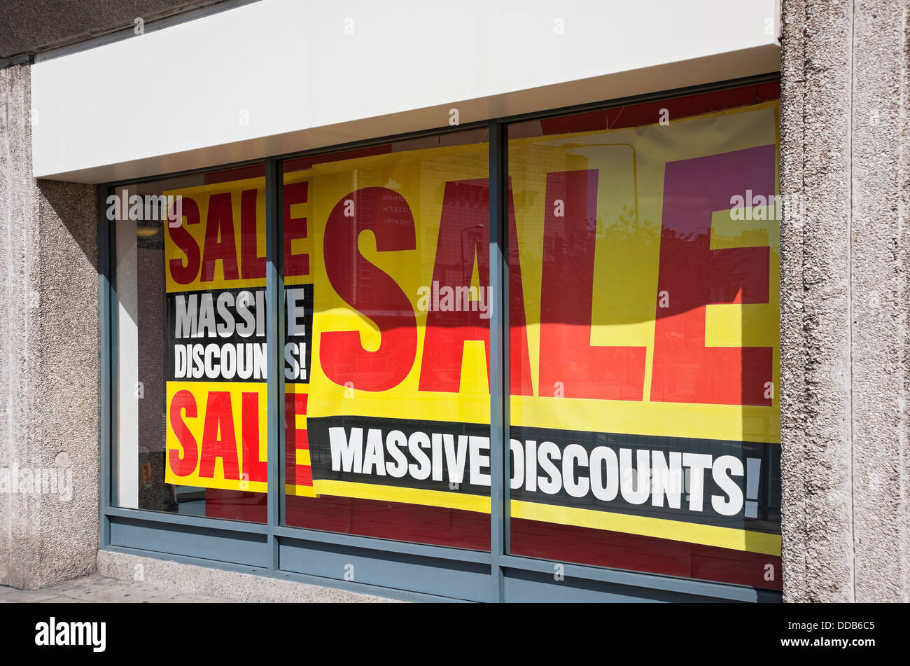 Close up of discount sale generic sign in shop store window exterior ...