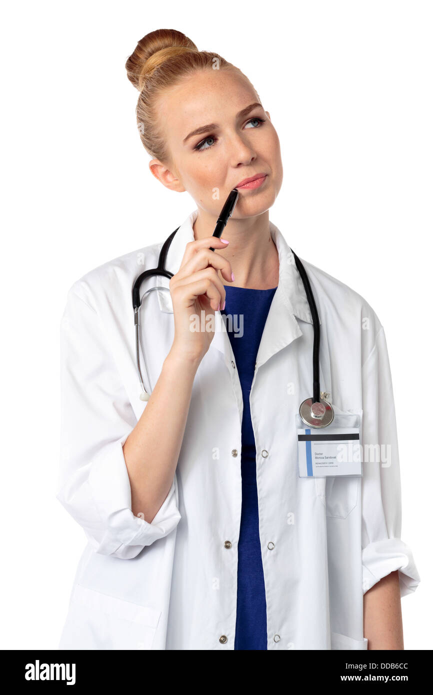 Female doctor lost in thought standing with her pen to her mouth ...