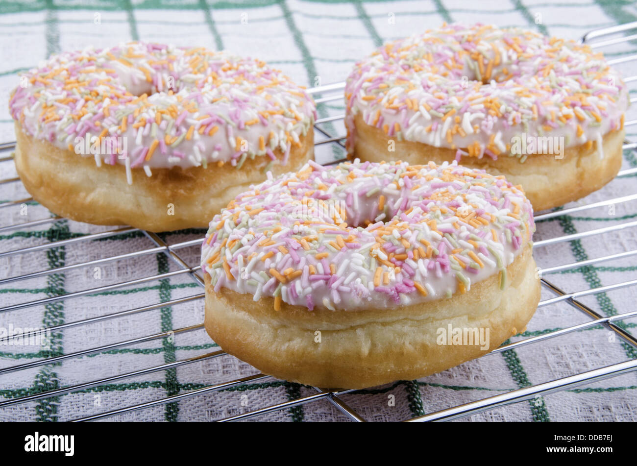 donuts with icing sugar and colored sprinkles Stock Photo - Alamy