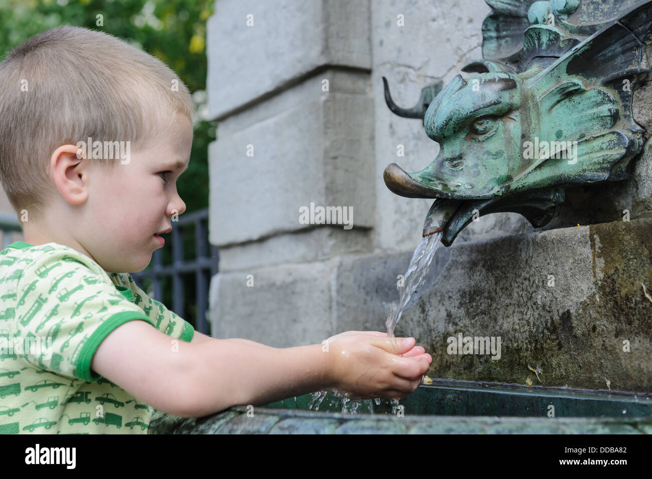 Young boy catching water in hands at fountain, Gothenburg, Sweden Stock ...