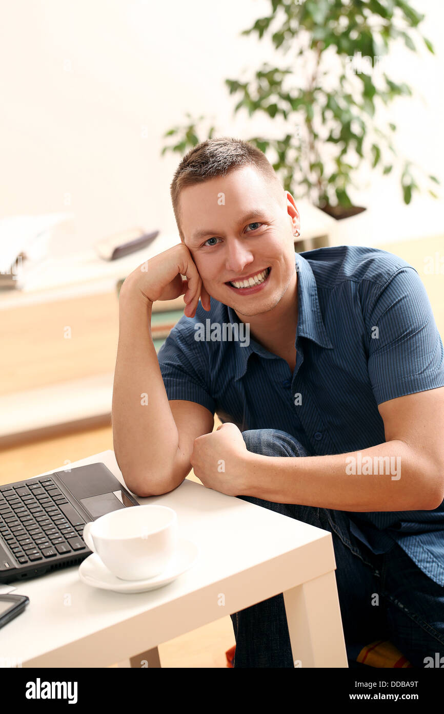 Young and happy guy relaxing at home Stock Photo - Alamy