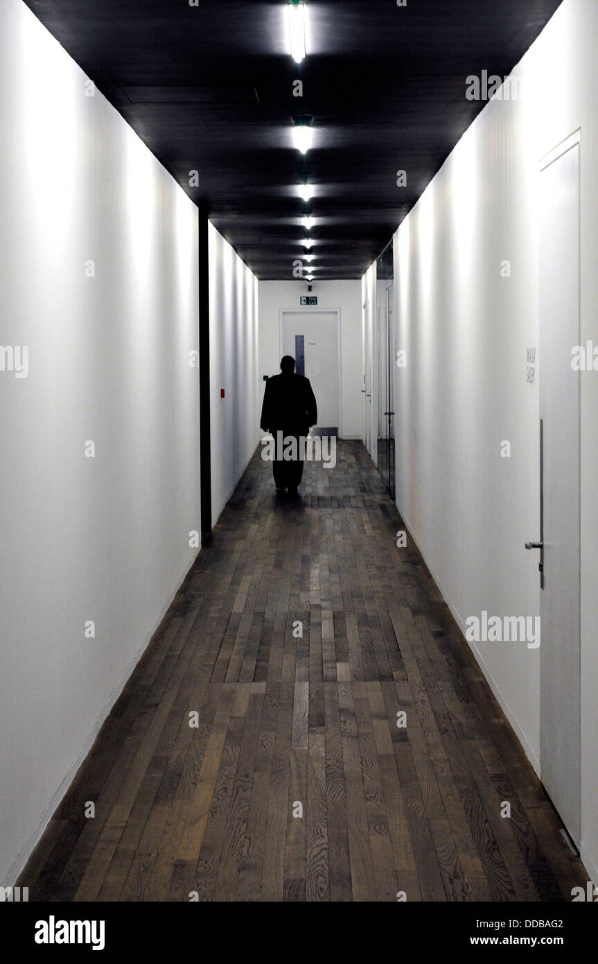 A rear view of a woman walking in a corridor, London, UK Stock Photo ...