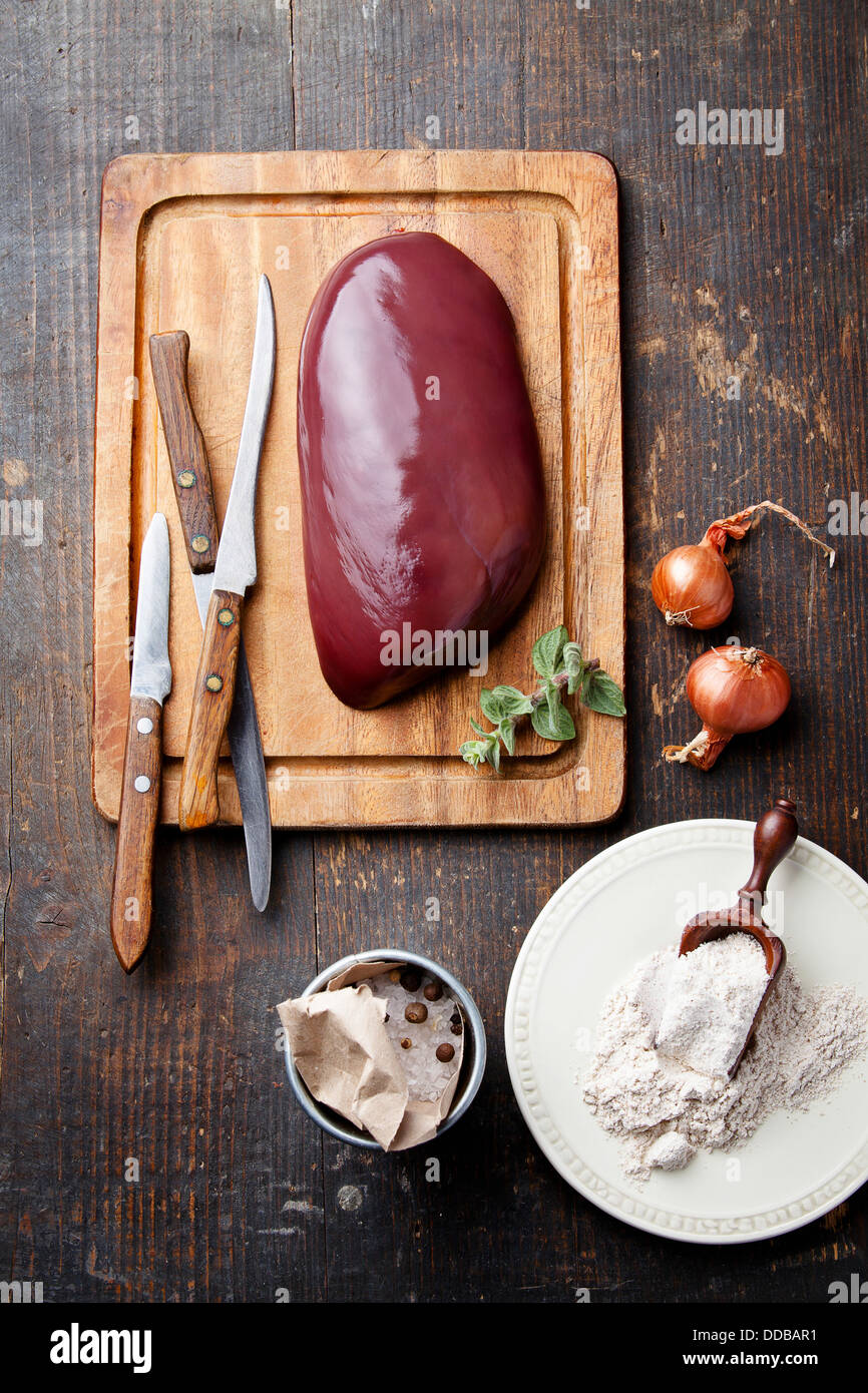 Raw liver with ingredients on wooden textured table Stock Photo - Alamy