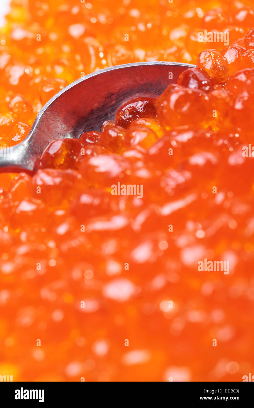 Close up of red delicious caviar with spoon inside Stock Photo - Alamy