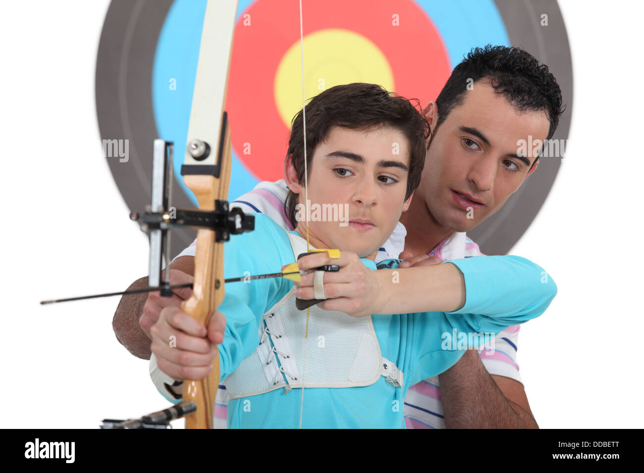 Boy having archery lesson Stock Photo - Alamy
