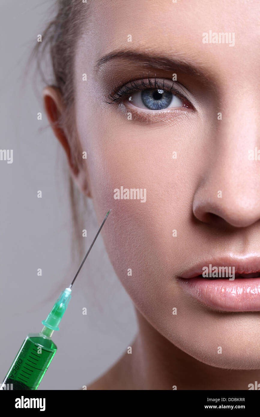 Beautiful woman gets an injection in her face Stock Photo - Alamy