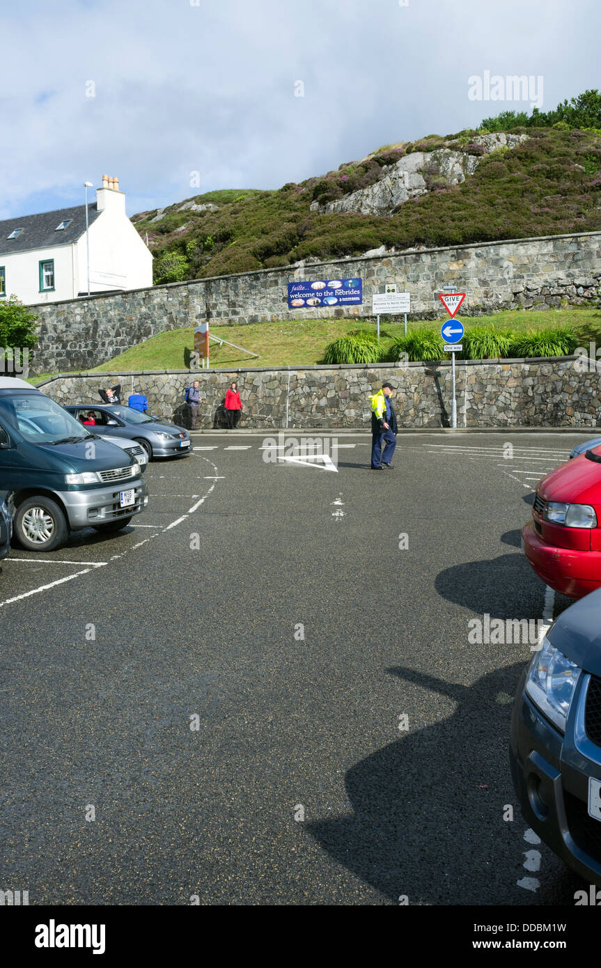 Cars and passengers waiting to board the MV Hebrides at Tarbert ferry ...