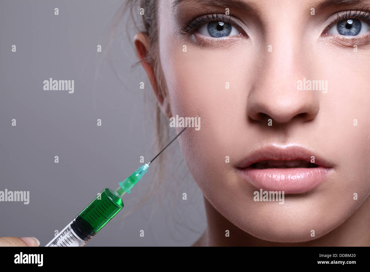 Beautiful woman gets an injection in her face Stock Photo - Alamy