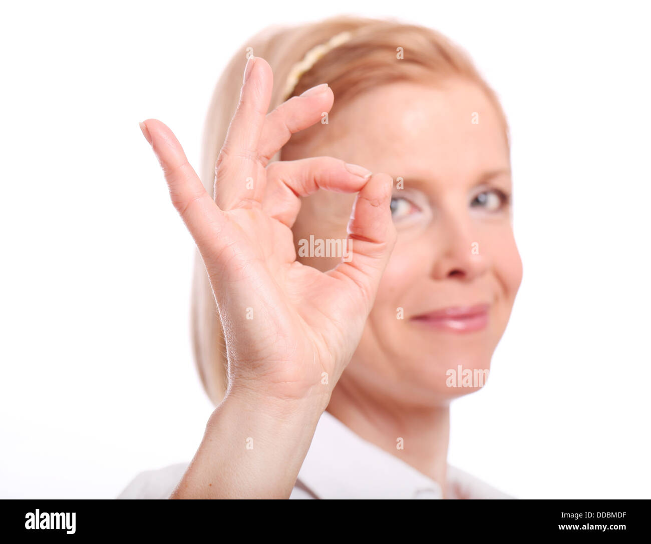 Beautiful mid aged woman showing ok gesture Stock Photo - Alamy