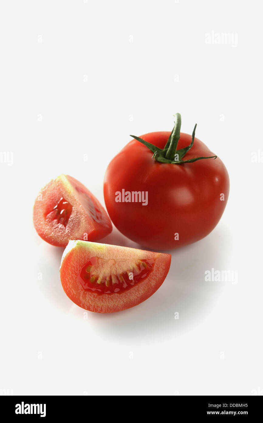 Whole and cut out tomato on white background Stock Photo - Alamy