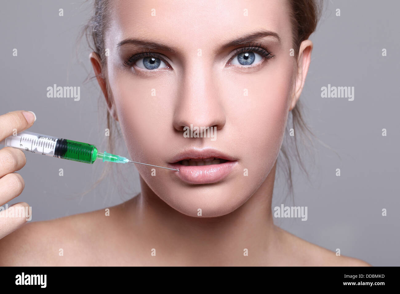 Beautiful woman gets an injection in her face Stock Photo - Alamy