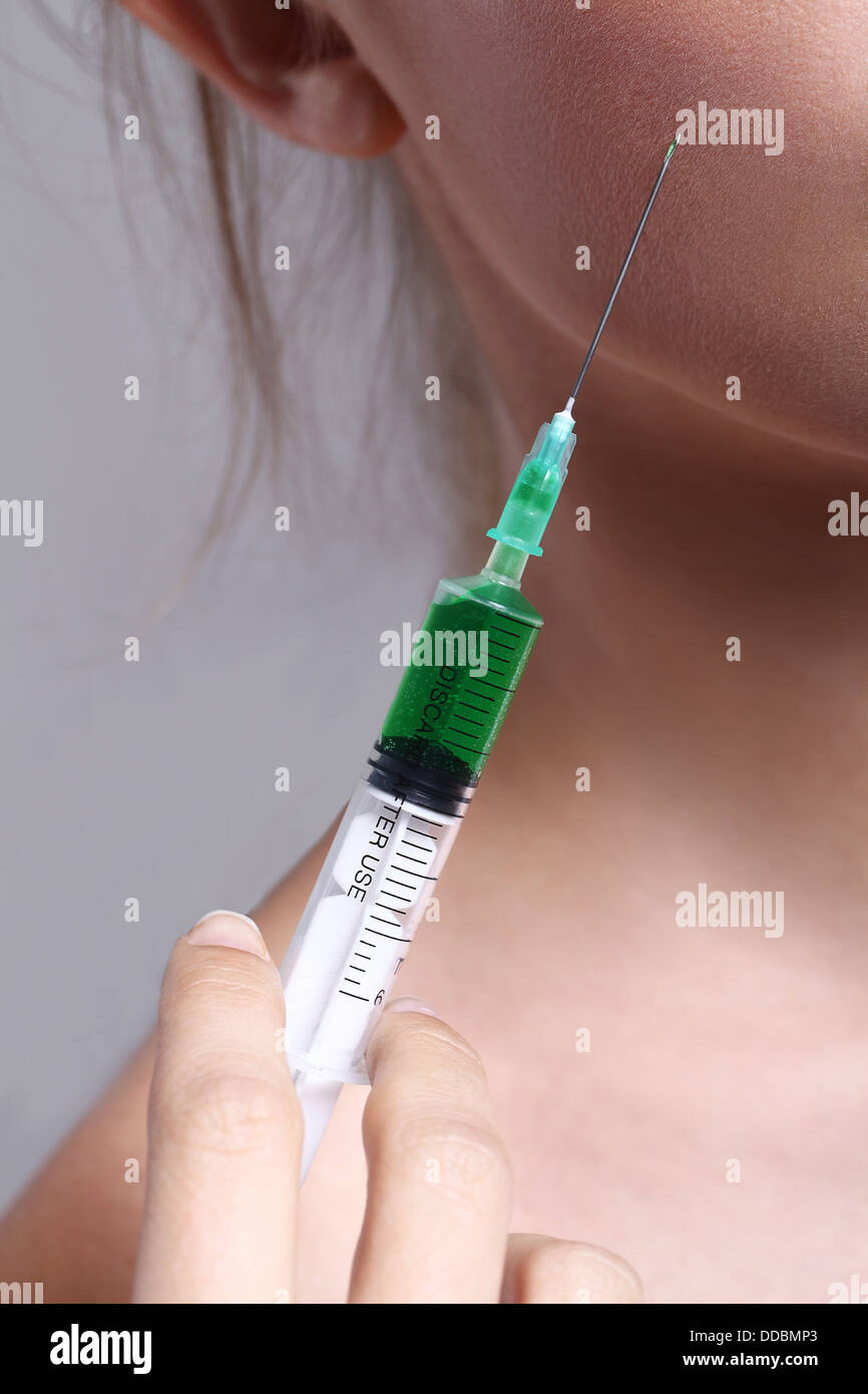 Beautiful woman gets an injection in her face Stock Photo - Alamy
