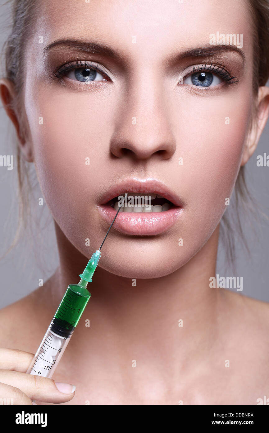 Beautiful woman gets an injection in her face Stock Photo - Alamy