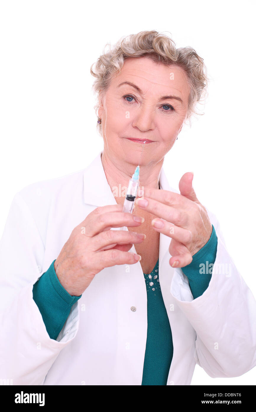 Old female doctor with syringe over a white Stock Photo - Alamy