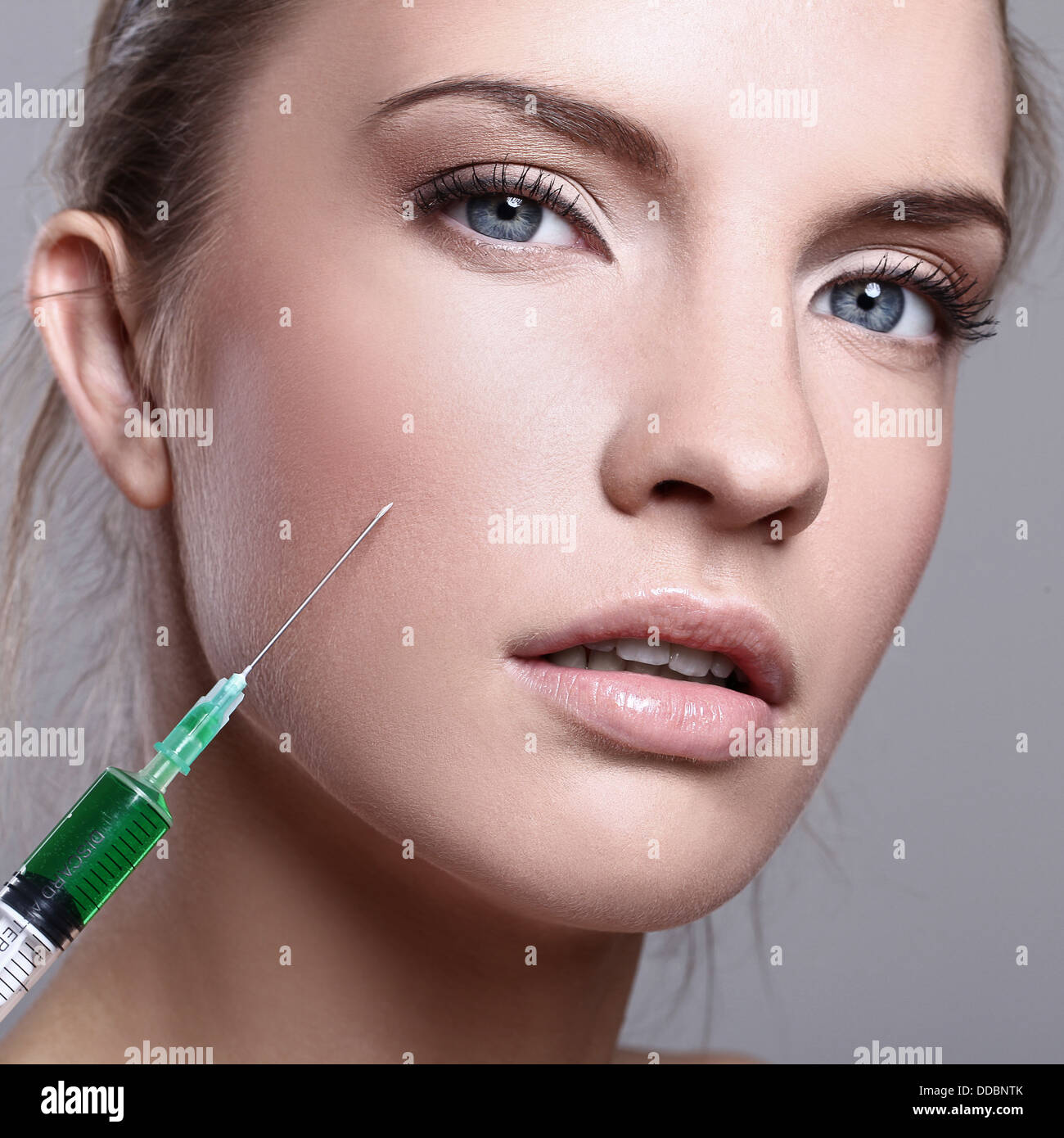 Beautiful woman gets an injection in her face Stock Photo - Alamy