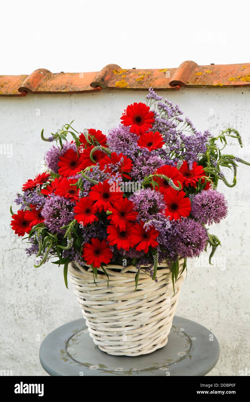 Mixed flowers in a basket Stock Photo - Alamy