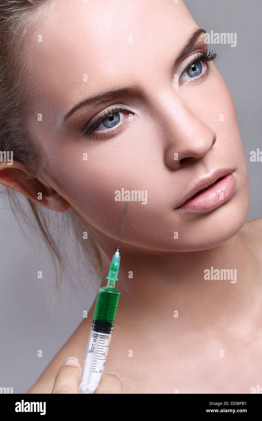 Beautiful woman gets an injection in her face Stock Photo - Alamy