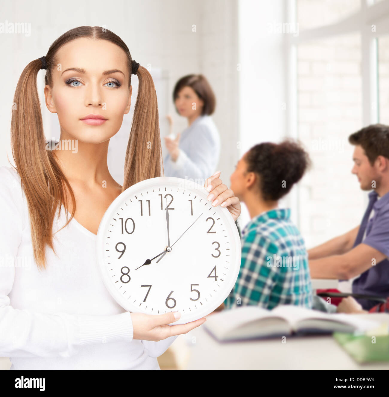 student showing clock Stock Photo - Alamy