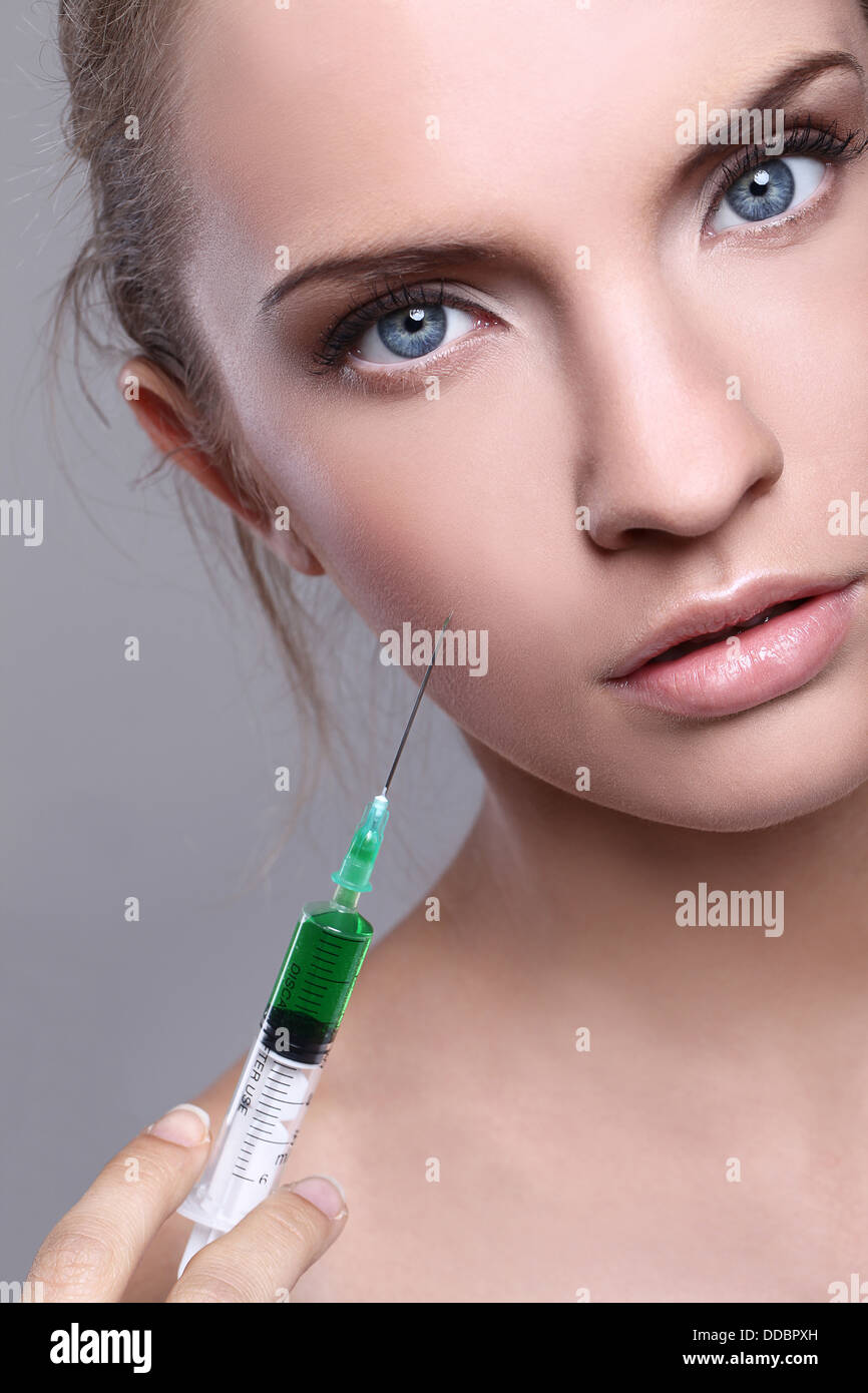 Beautiful woman gets an injection in her face Stock Photo - Alamy