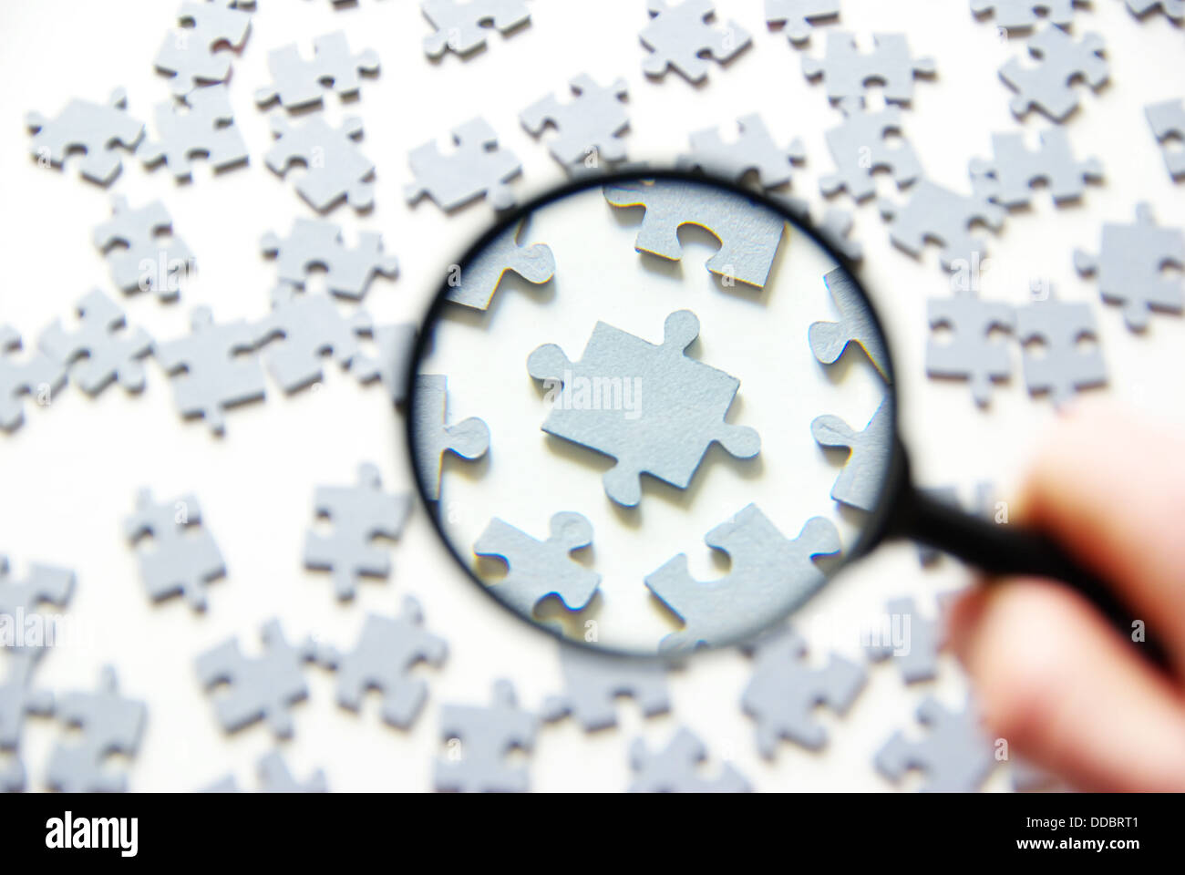magnifying glass and puzzle Stock Photo - Alamy