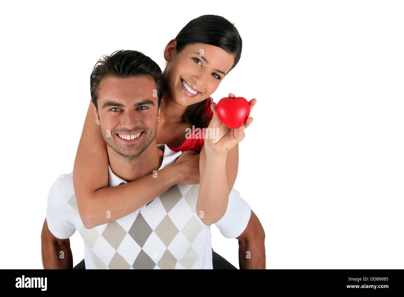 Couple holding heart-shaped object Stock Photo - Alamy