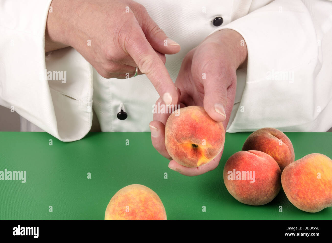 female chef shows with her index finger on a peach Stock Photo - Alamy