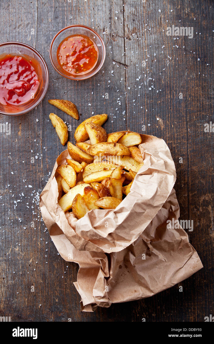 Fried potato "country-style" in paper bag Stock Photo - Alamy