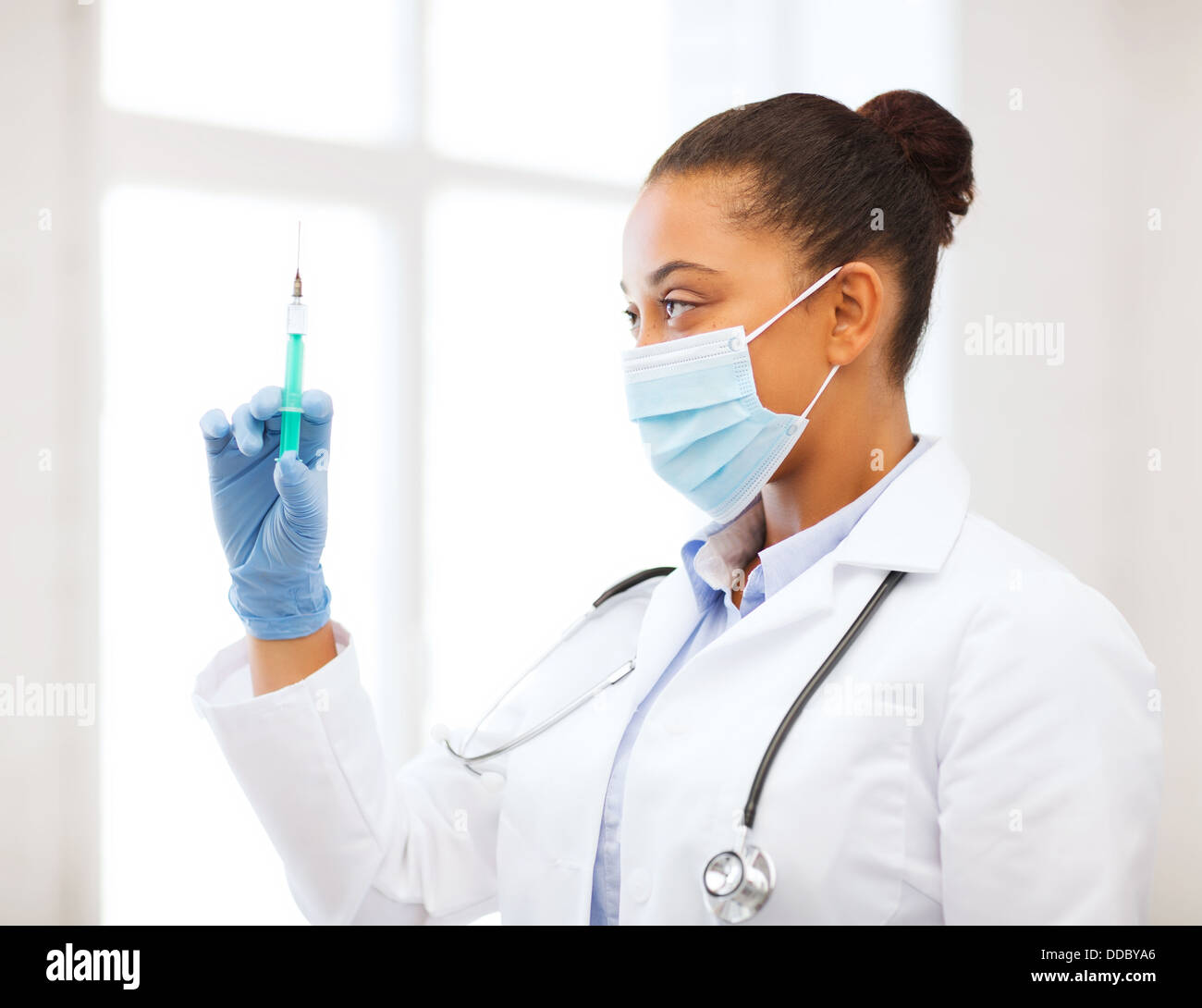african doctor holding syringe with injection Stock Photo - Alamy