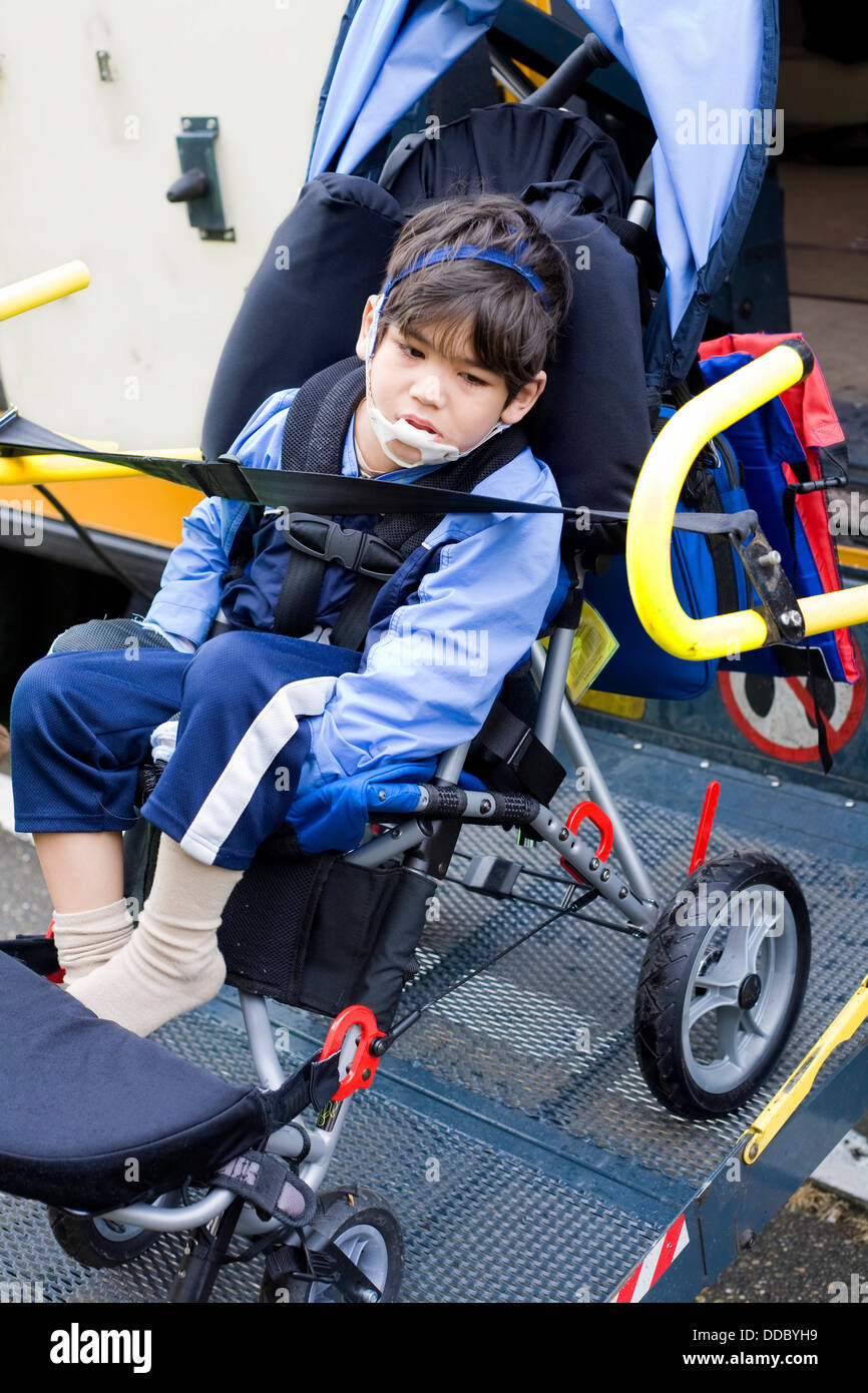 Disabled little boy on school bus wheelchair lift Stock Photo - Alamy
