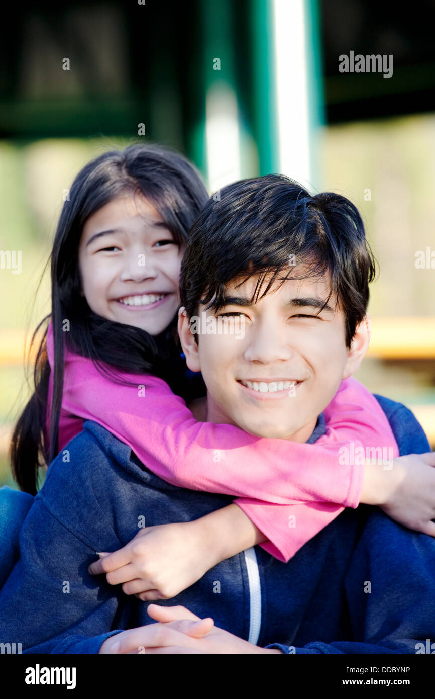 Sister hugging younger brother hi-res stock photography and images - Alamy