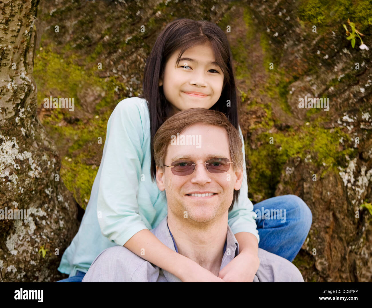 Little girl hugging father around neck Stock Photo - Alamy