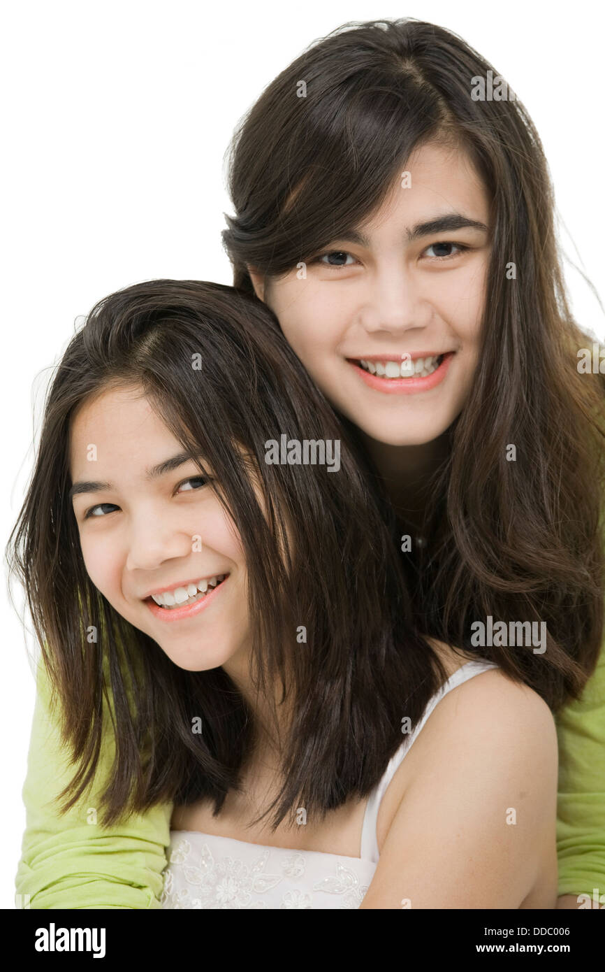 Two sisters together, isolated on white Stock Photo - Alamy