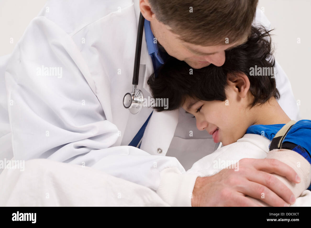 Male doctor comforting disabled toddler patient Stock Photo - Alamy