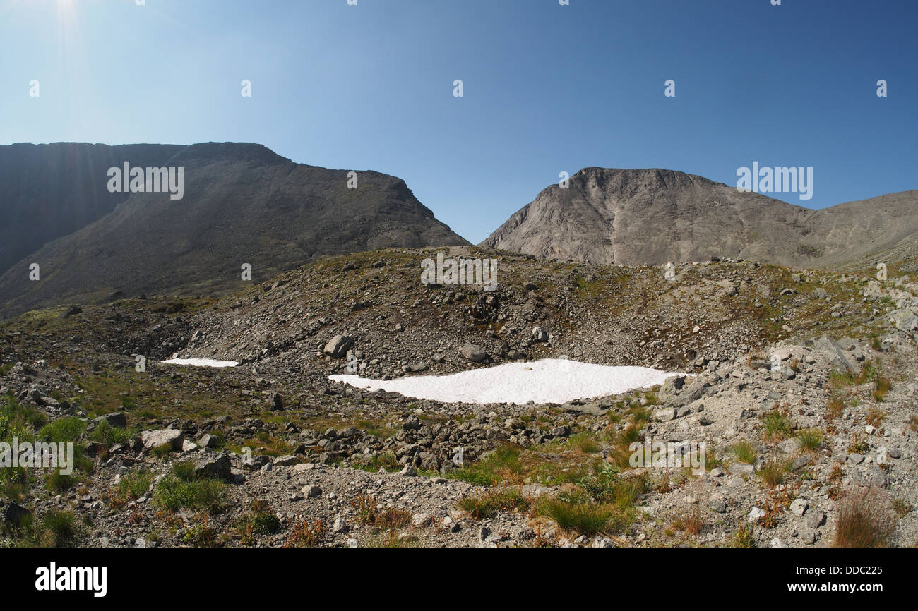 Snow in the mountains in summer Stock Photo - Alamy