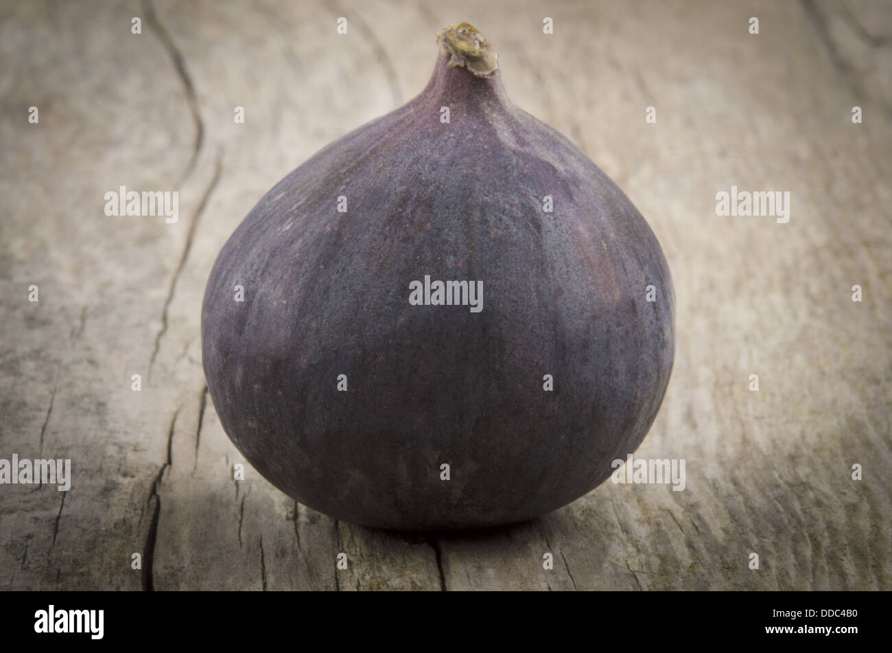 whole fig on a timber board Stock Photo - Alamy