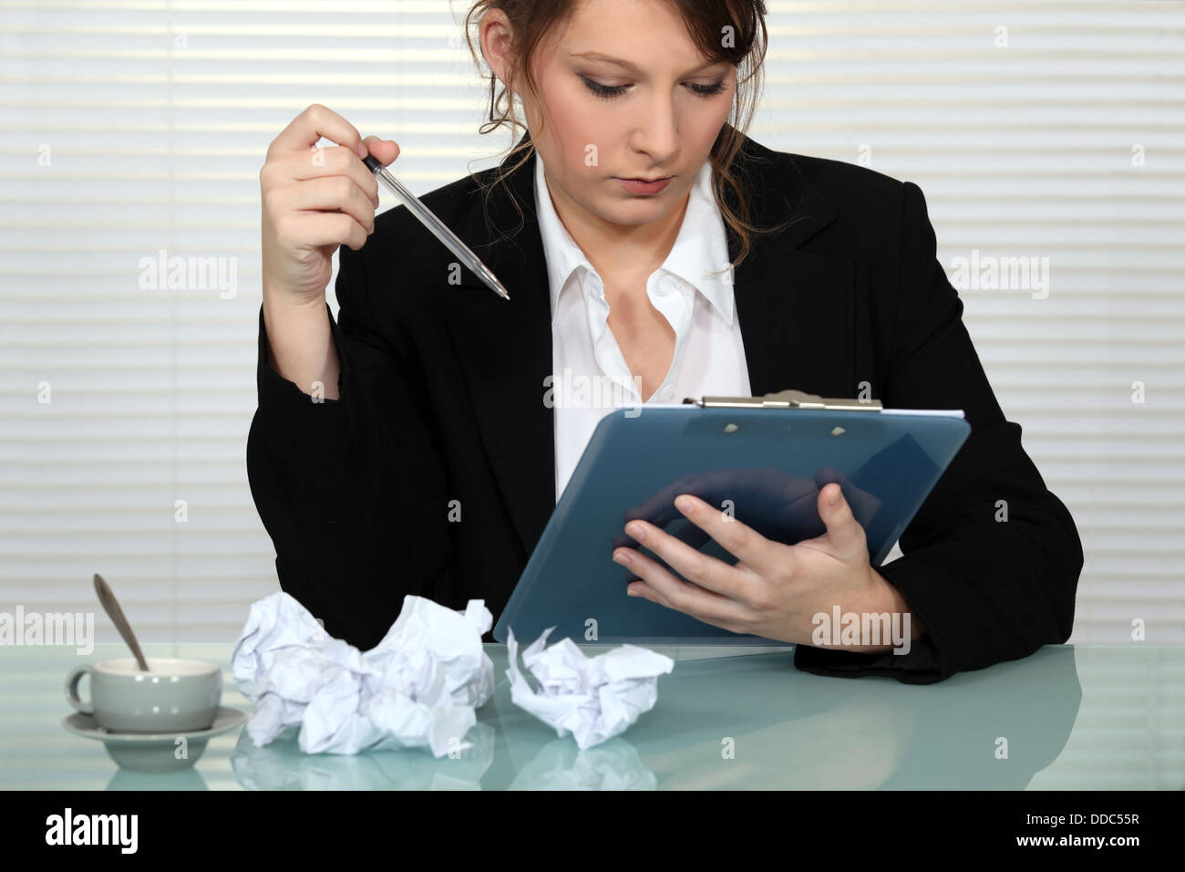 Businesswoman struggling to write presentation Stock Photo - Alamy
