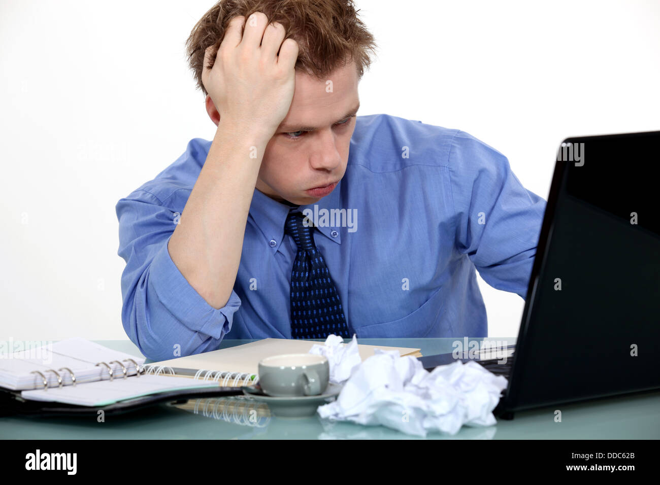 Stressed man sat at desk Stock Photo - Alamy