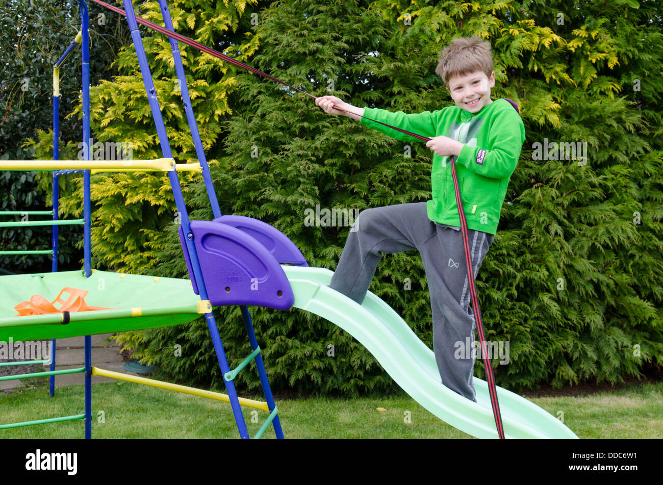 Child climbing up slide hi-res stock photography and images - Alamy