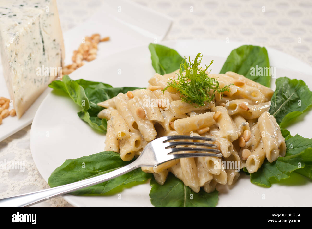 Italian pasta penne gorgonzola and pine nuts Stock Photo - Alamy