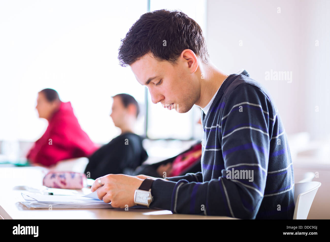 young, handsome male college student sitting in a classroom full Stock ...