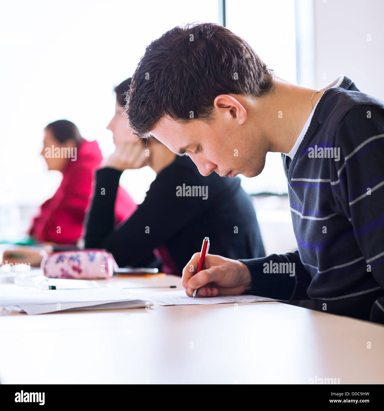 young, handsome male college student sitting in a classroom full Stock ...
